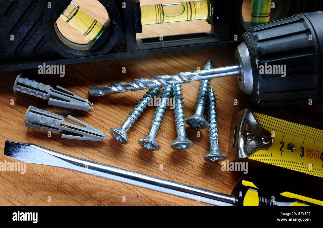 General view of screws, a tape measure, a screwdriver, rawl plugs and a ...