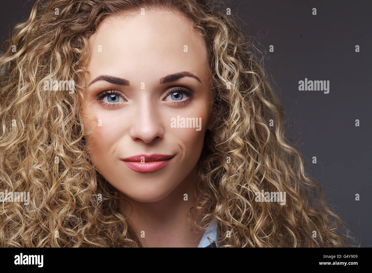 Portrait of perfect woman with curly hair Stock Photo - Alamy