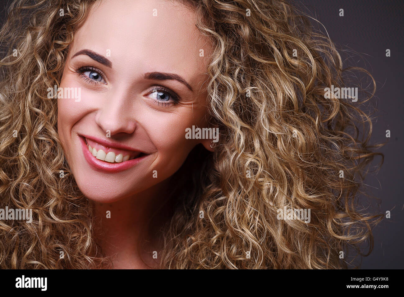 Portrait of curly woman Stock Photo - Alamy