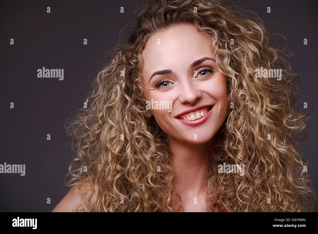 Portrait of curly woman Stock Photo - Alamy