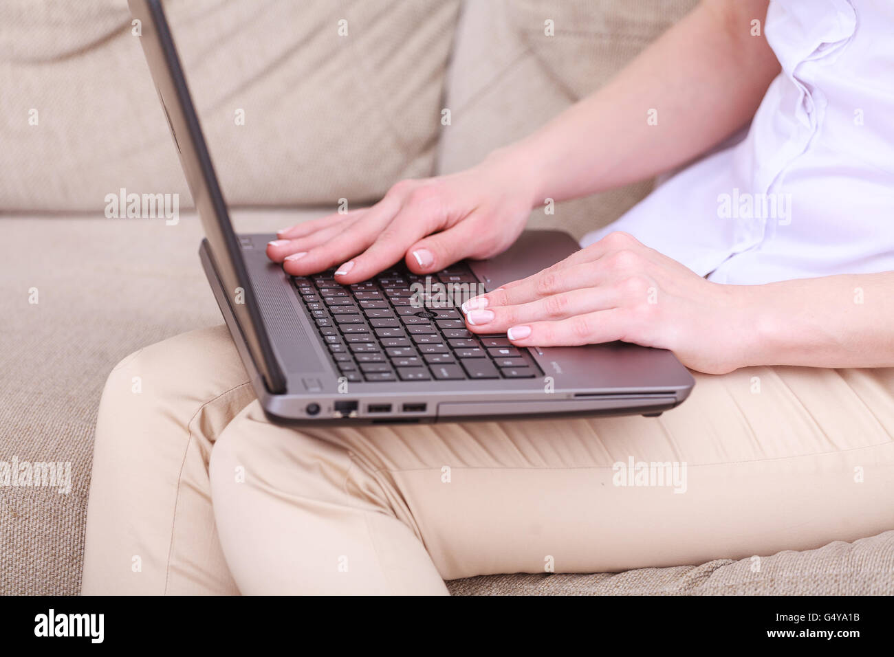 Woman sitting with laptop Stock Photo - Alamy
