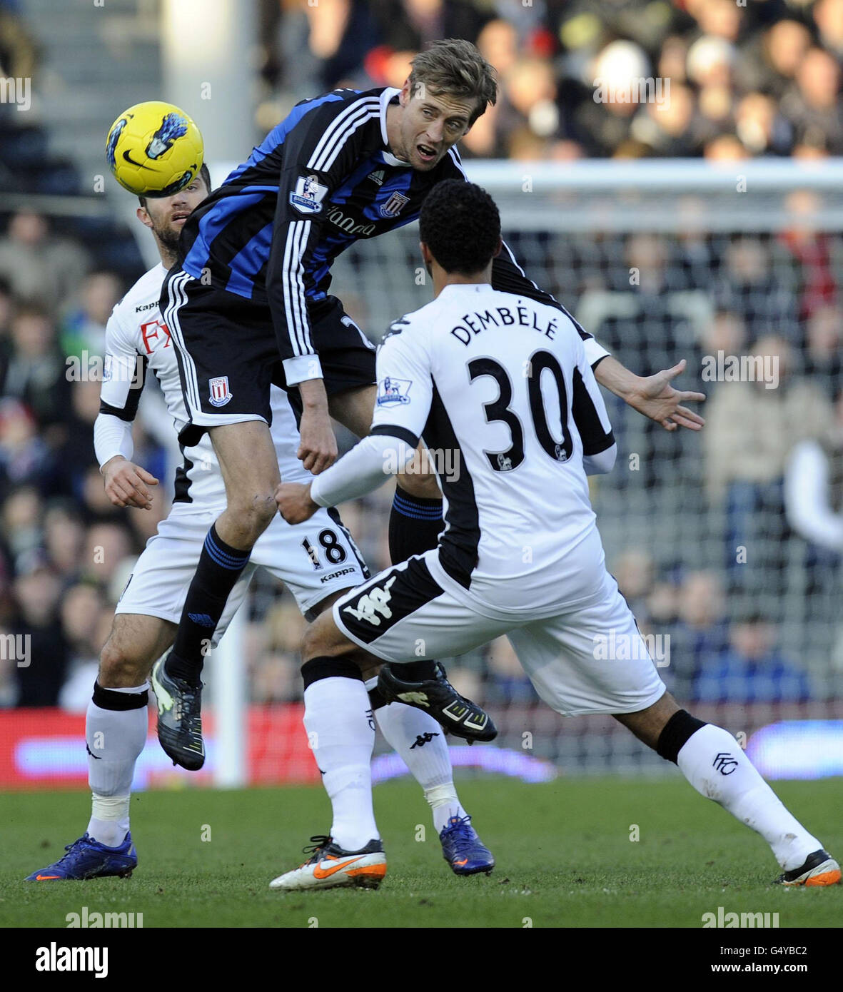 Fulham's Mousa Dembele and Aaron Hughes (back) combine to challenge ...