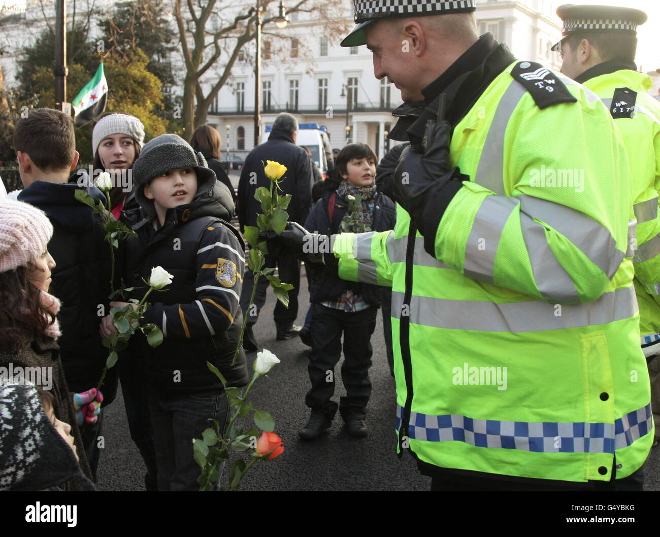 Children hand out flowers to police officers during a protest outside ...