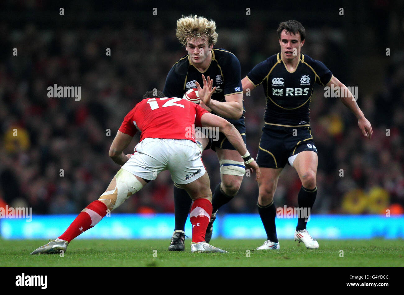 Scotland's Richie Gray is tackled by Wales' Jamie Roberts (left) during ...