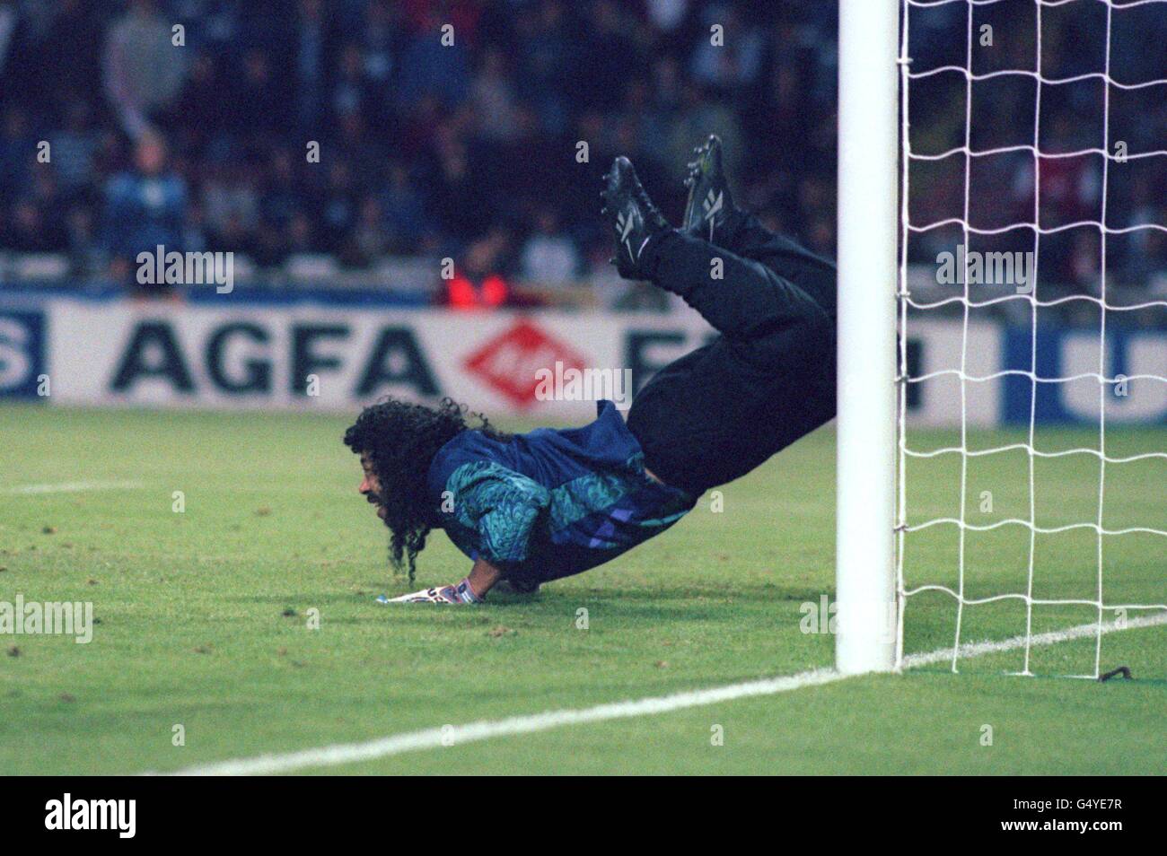 Colombian goalkeeper Rene Higuita clears the ball with an overhead kick ...