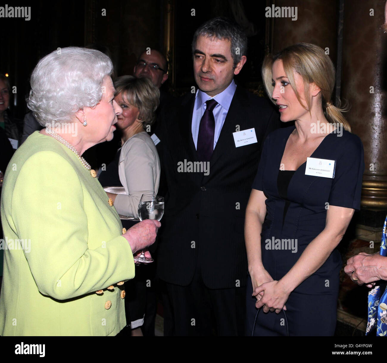 Queen Elizabeth II meet Rowan Atkinson (centre) and Gillian Anderson ...