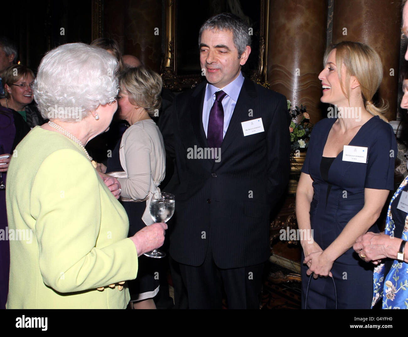 Queen Elizabeth II meet Rowan Atkinson (centre) and Gillian Anderson ...
