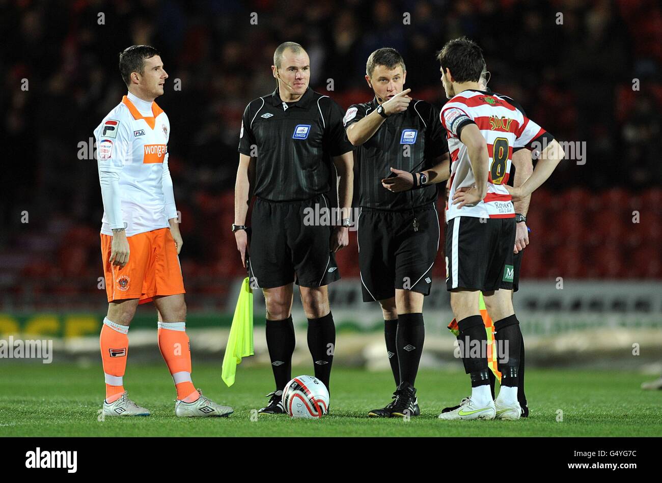 Referee Gary Sutton (2nd right) asks Doncaster Rovers' captain Brian ...