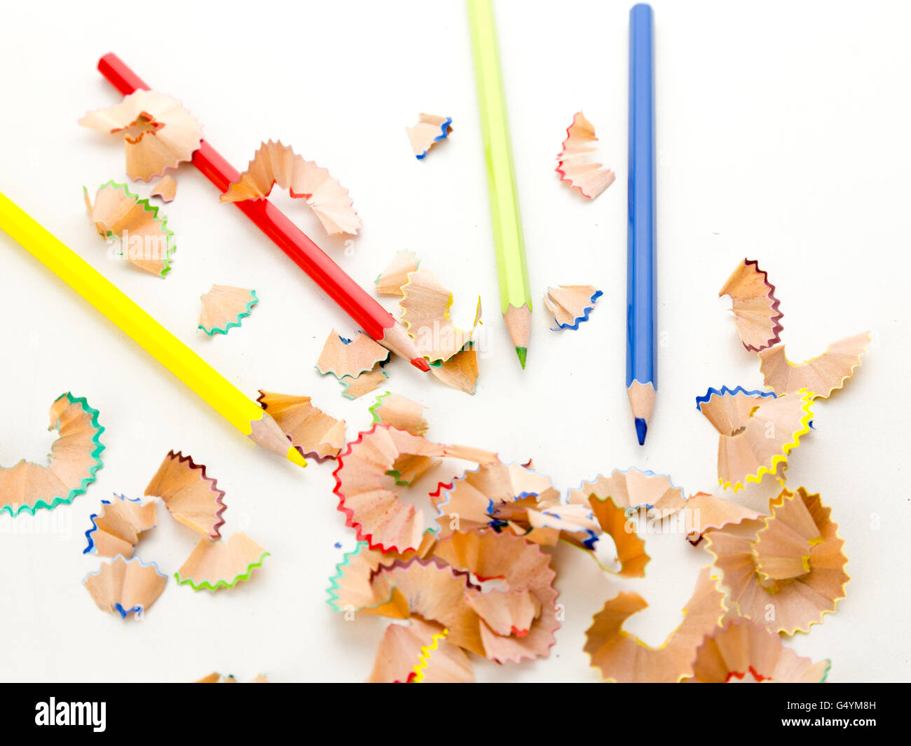 Colorful group of pencil crayons and shavings from sharpening on a ...