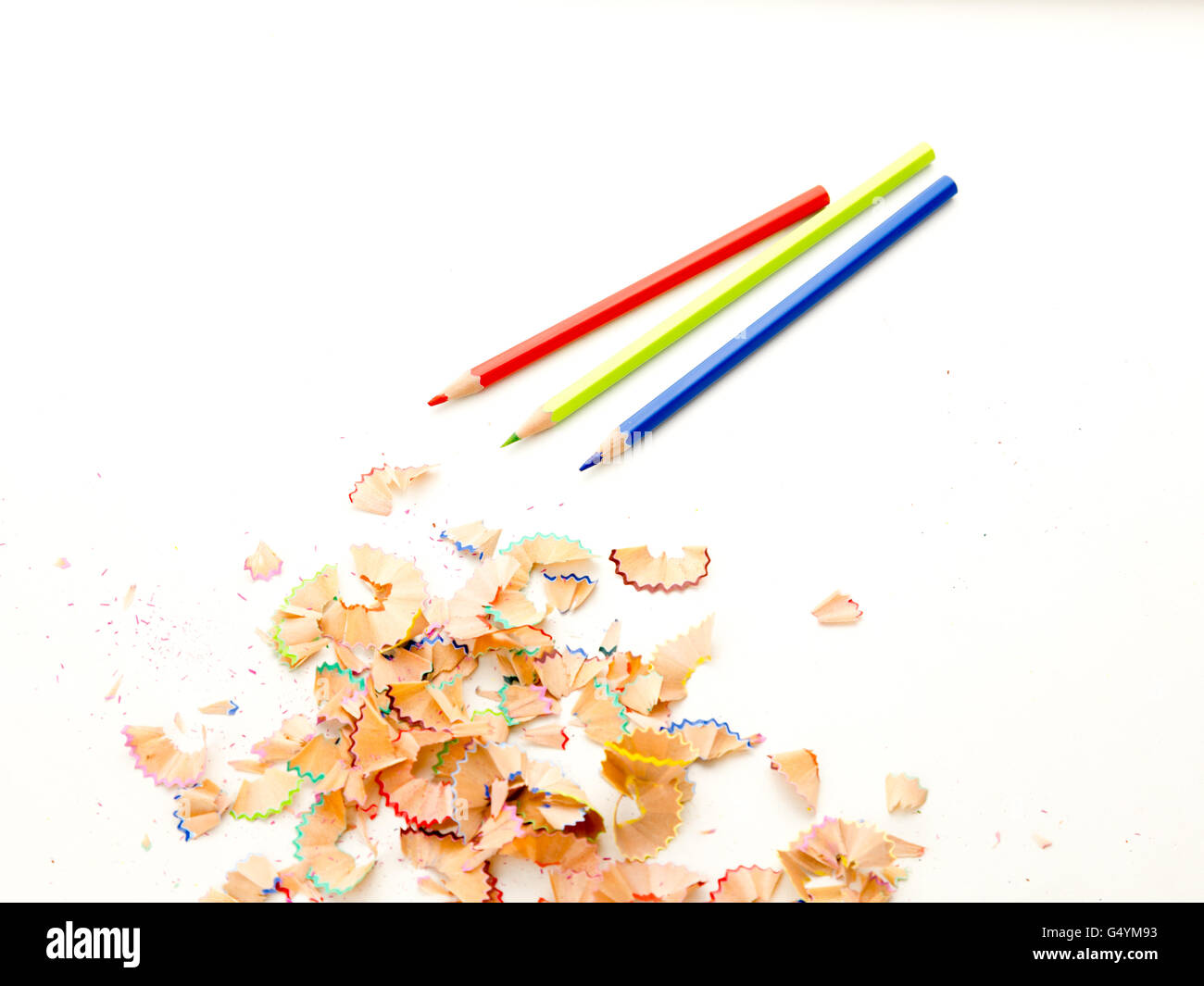 Colorful group of pencil crayons and shavings from sharpening on a ...