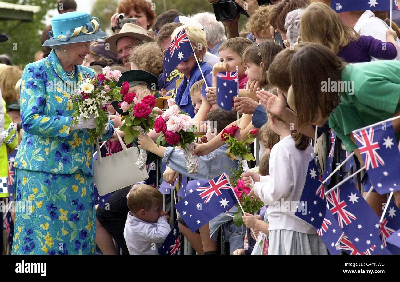 Queen Elizabeth II receives flowers from members of the crowd in ...