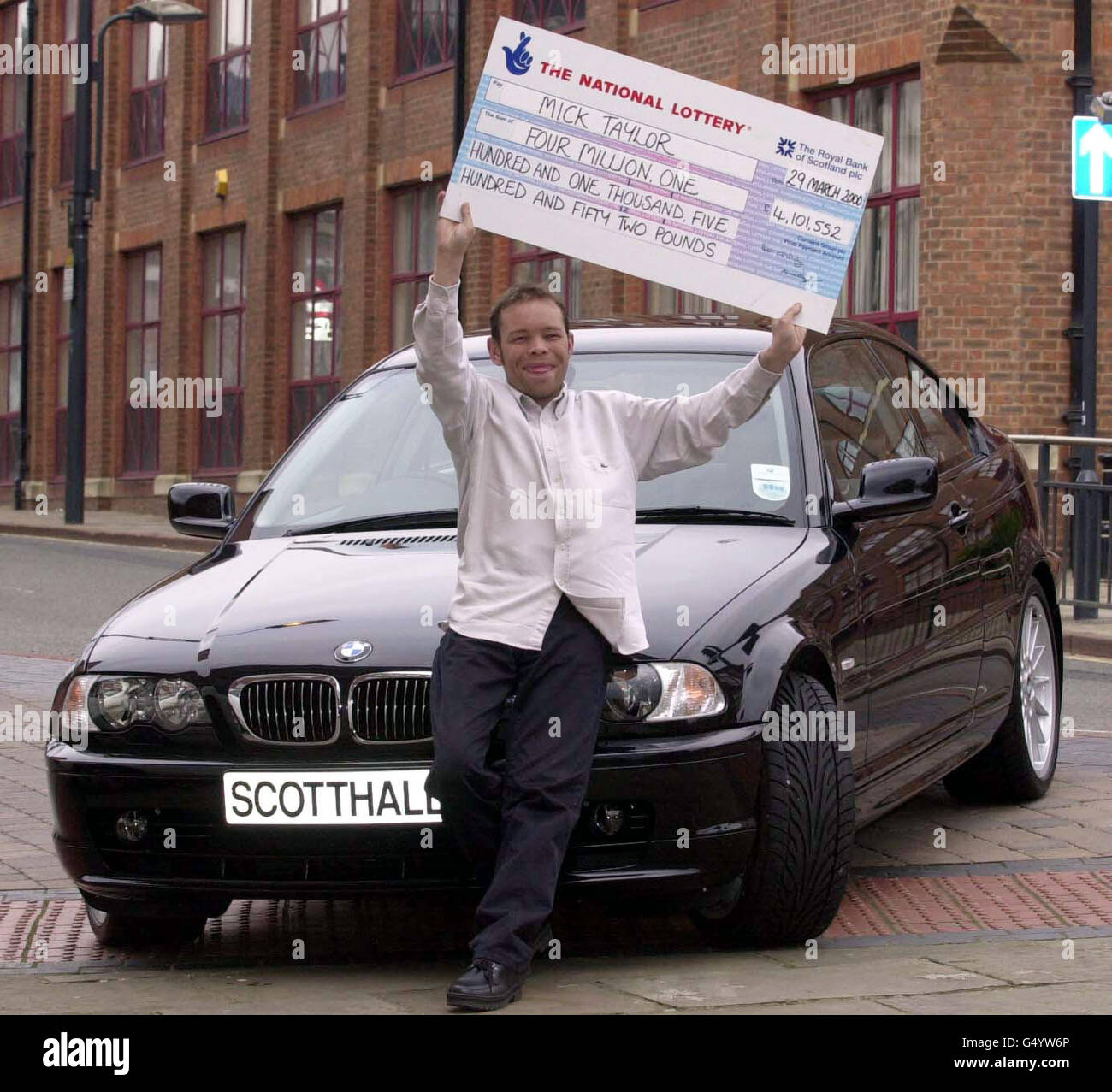 Waving cheque national lottery smiling black bmw car hi-res stock ...