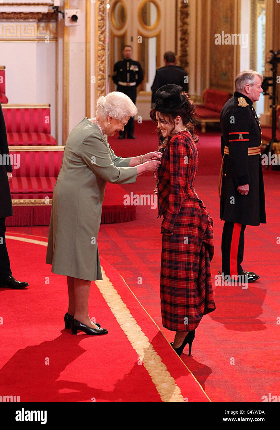 Queen Elizabeth II presents Helena Bonham Carter with her Commander of ...