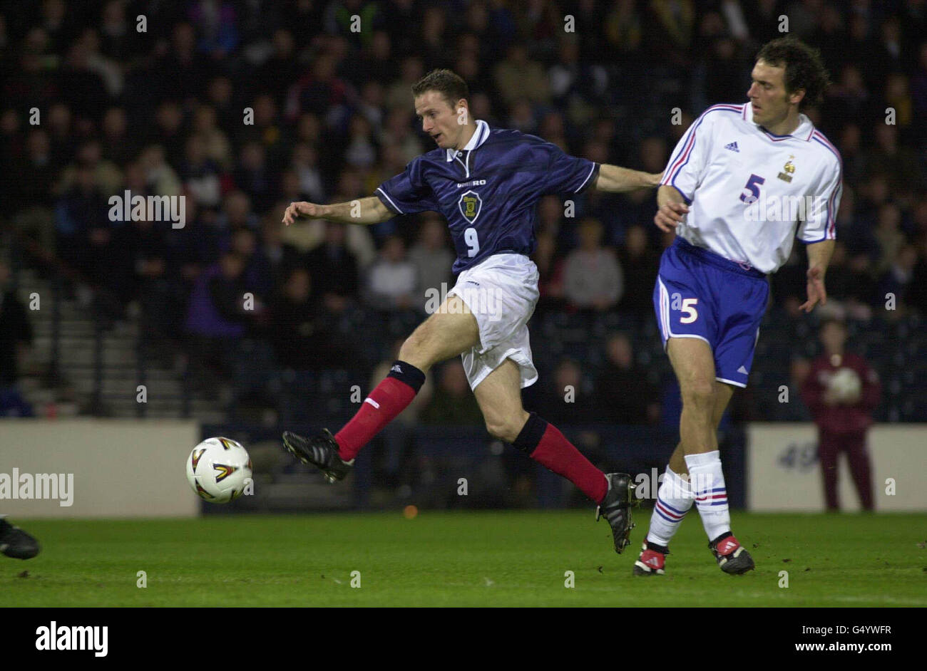 Scotland's Neil McCann (L) takes a shot at the French goal as Laurent ...