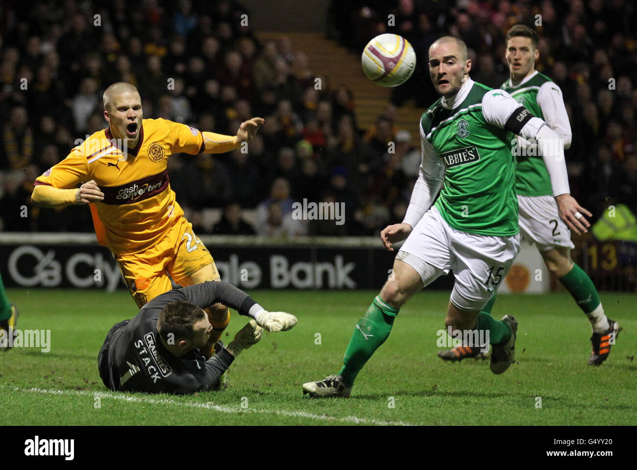 Motherwell's Henrik Ojama is brought down by Hibernian's goalkeeper ...
