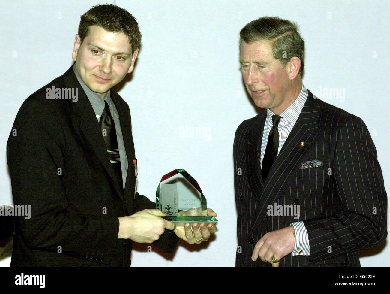 The Prince of Wales (R) presents a volunteer achievement award to Jon ...