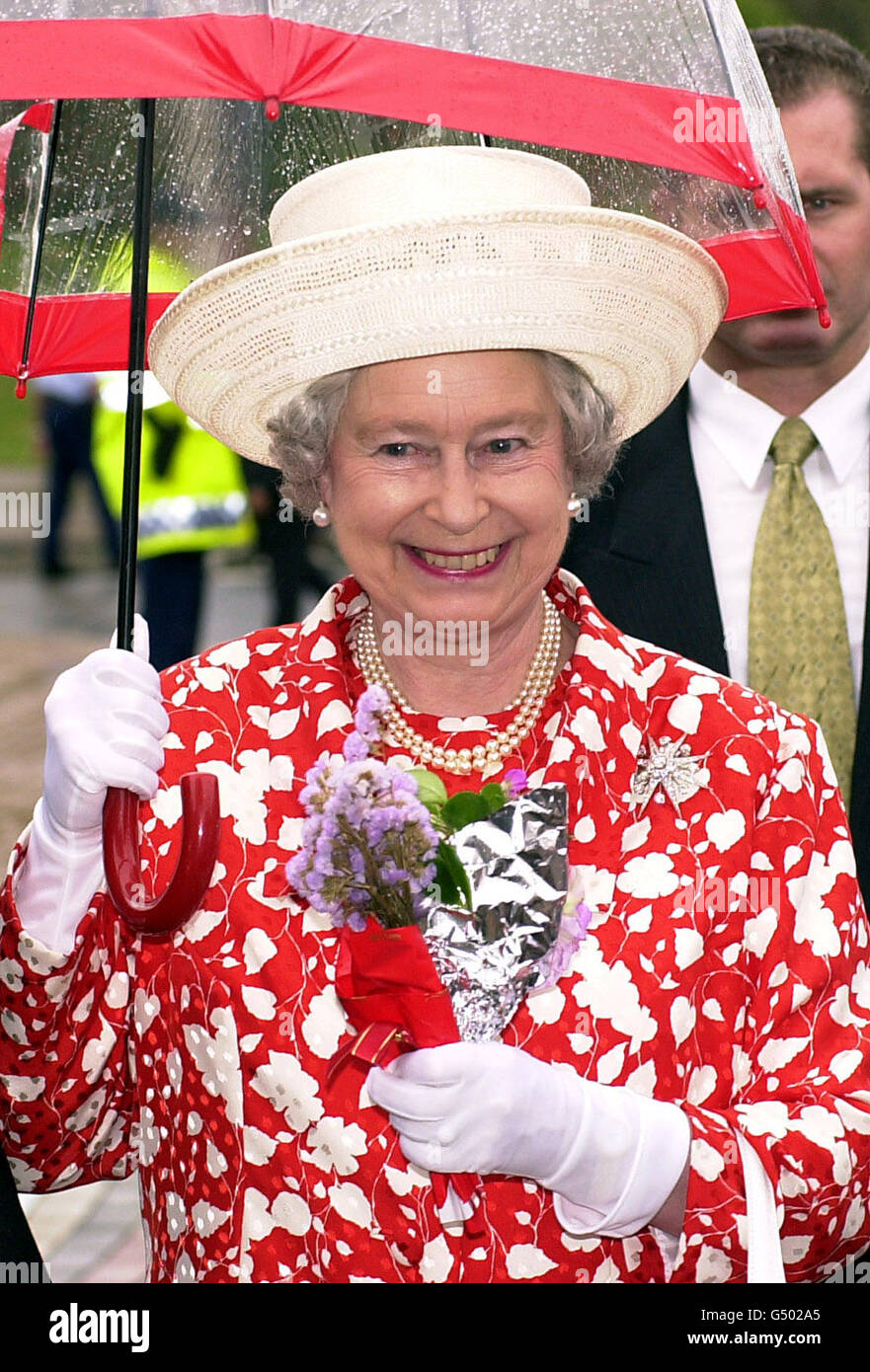 Queen Olympic stadium. Queen Elizabeth II arrives during a shower at ...