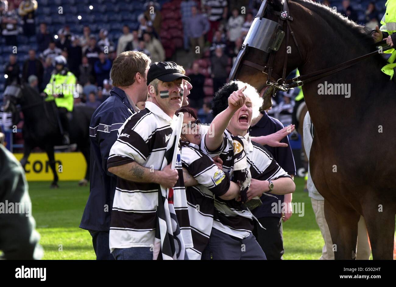 Mounted police move in to disperse Hull fans from the pitch after their ...