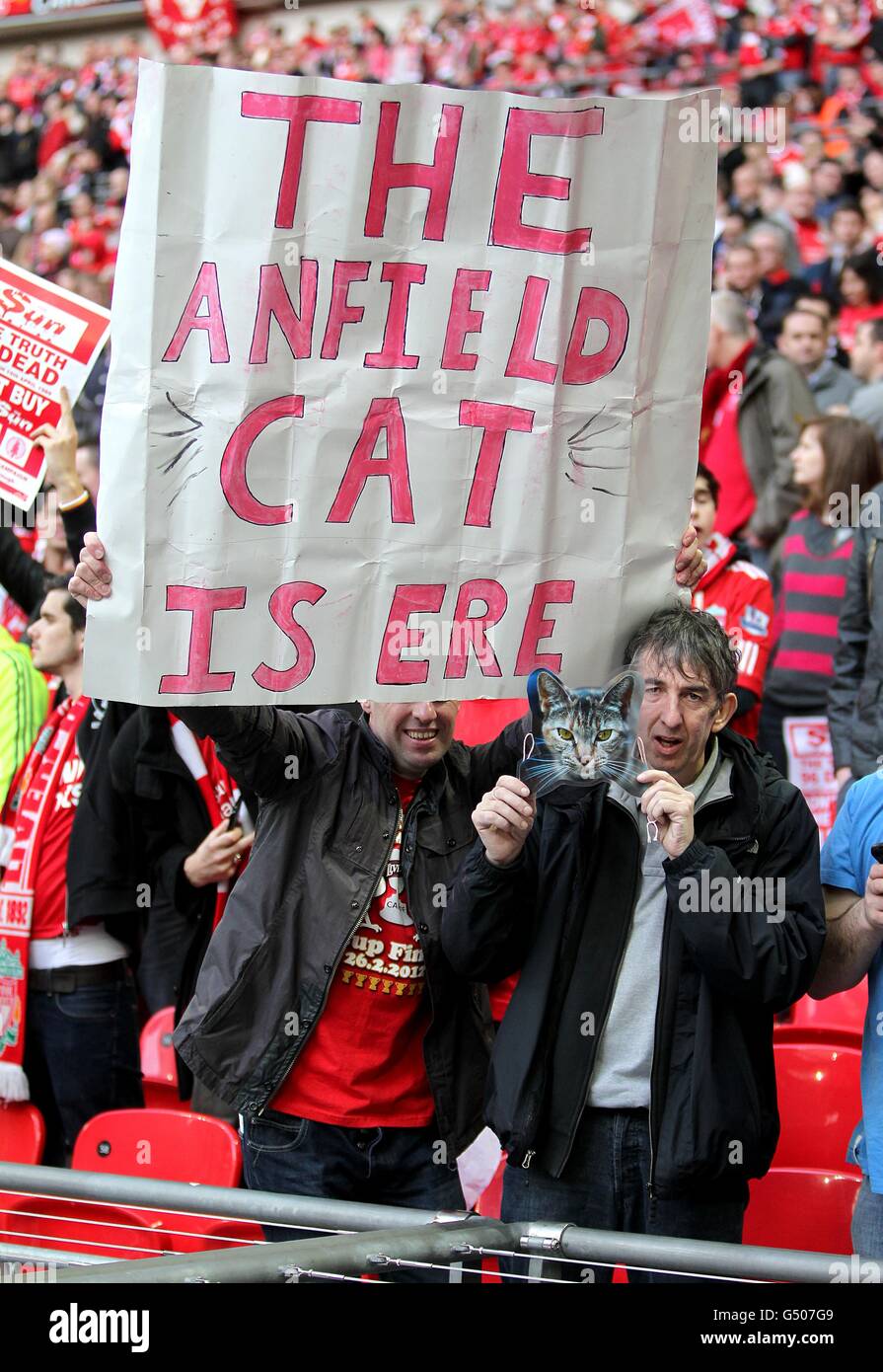 Liverpool fans with a sign paying tribute to the Anfield Cat in the ...