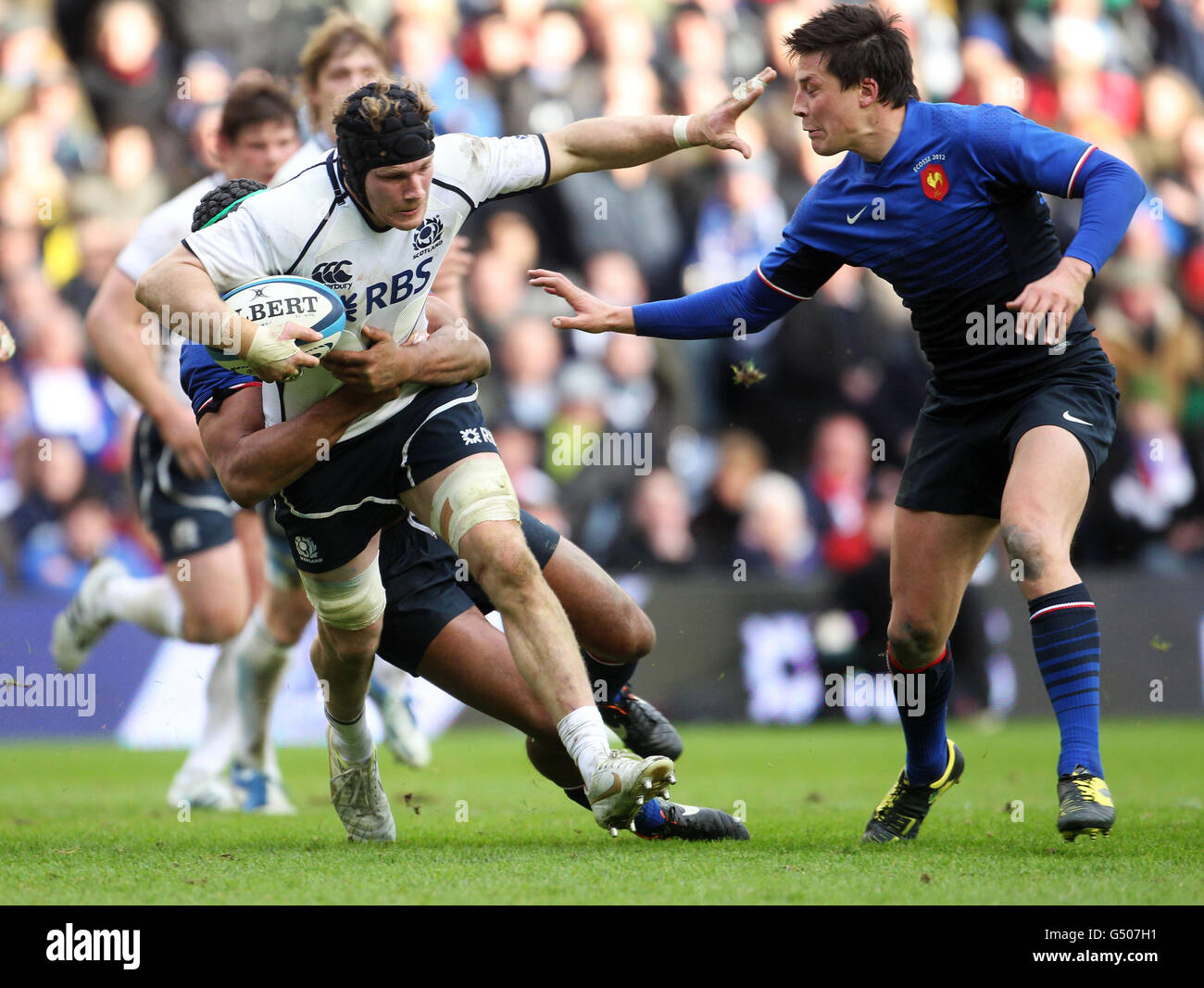 Scotland's Ross Rennie evades a tackle from France's Maxime Medard ...
