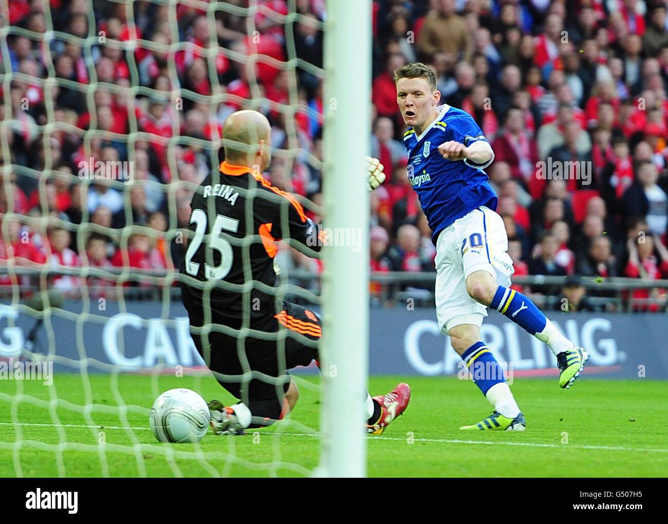 Cardiff City's Joe Mason (right) scores the first goal of the game past ...