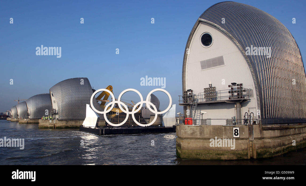 Giant Olympic rings pass the Thames Barrier, as they were launched on ...