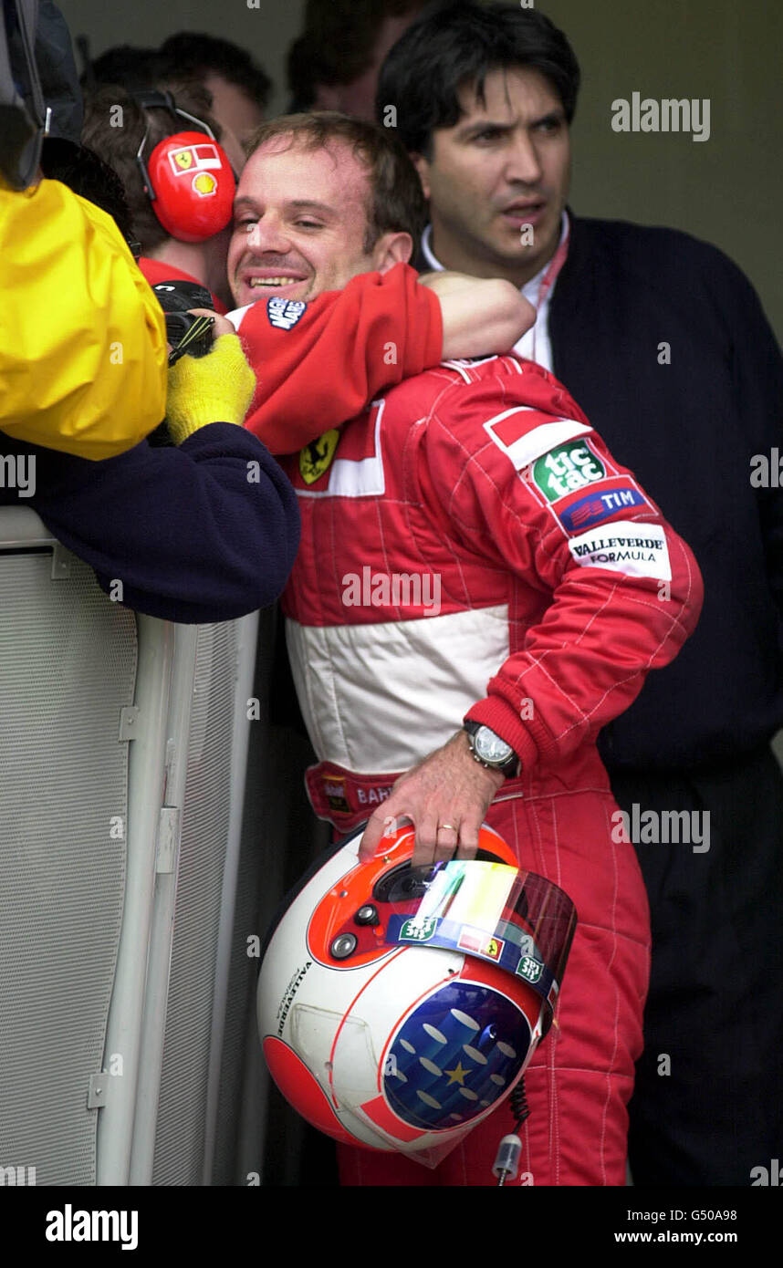 Rubens Barrichello celebrates pole position with one of the Ferrari ...