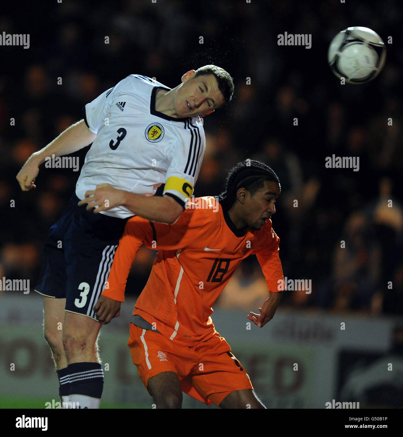 Scotland's Paul Hanlon heads from Holland's Jerson Cabral (right ...