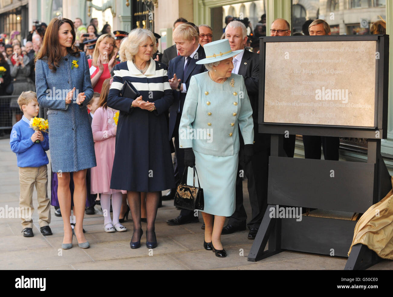 Queen Elizabeth II (right) unveils a plaque outside Fortnum and Mason ...