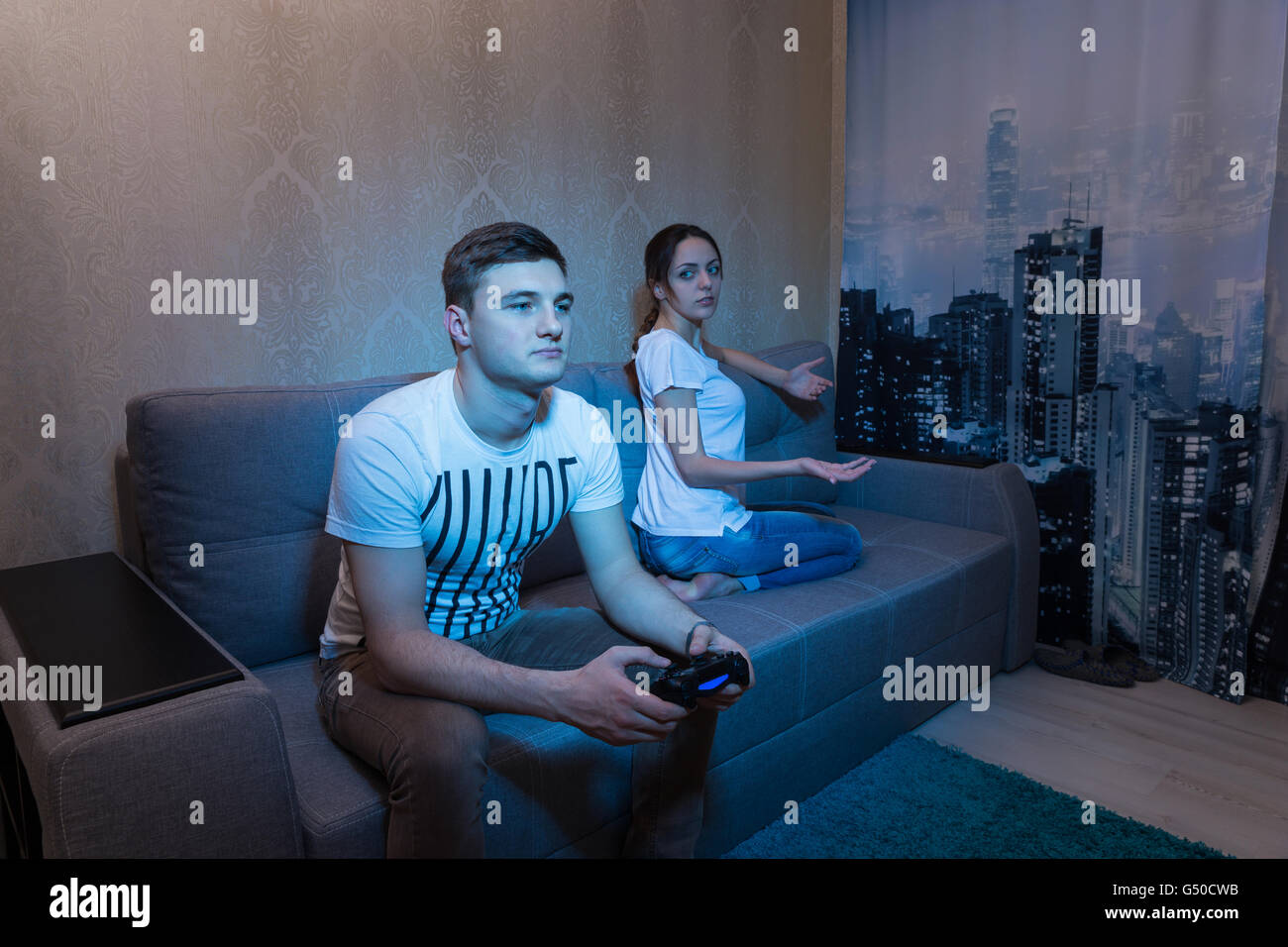 Young serious man playing a video game and totaly passionate about the ...