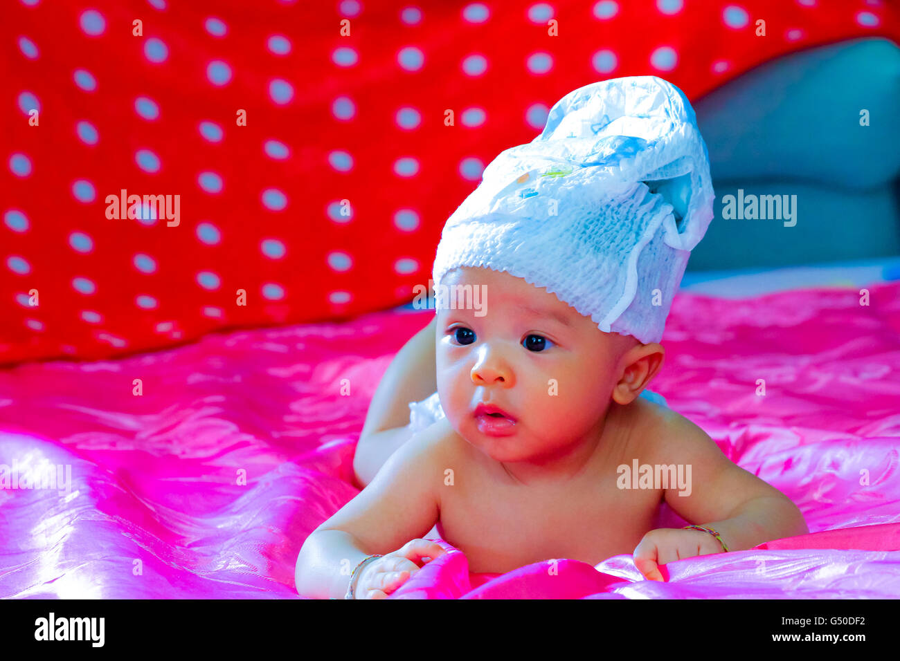 adorable little boy with pamper on head,little boy in bedroom. Newborn ...