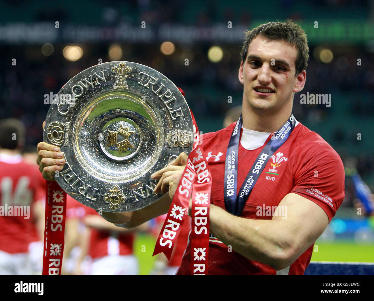 Wales' captain Sam Warburton hold up the Triple Crown trophy after ...
