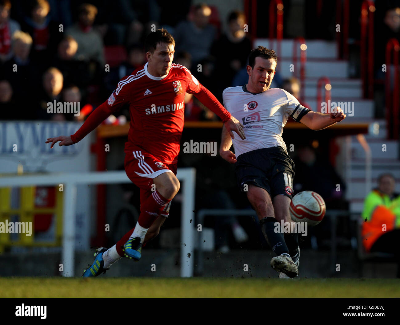 Swindon Town's Lee Cox (left) and Accrington Stanley's Luke Joyce ...