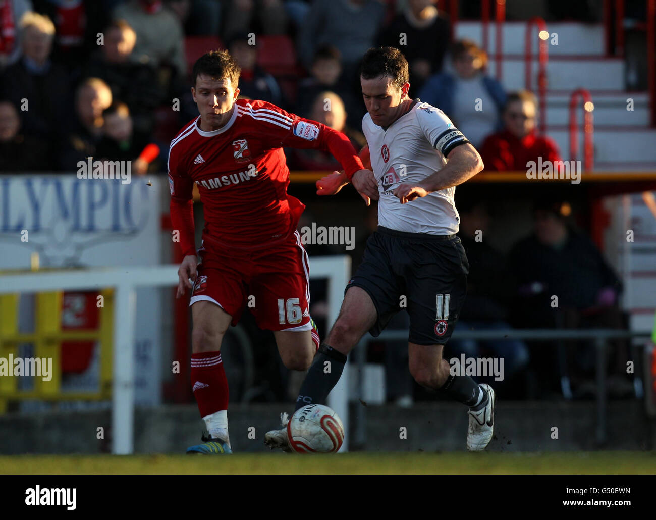 Swindon Town's Lee Cox (left) and Accrington Stanley's Luke Joyce ...