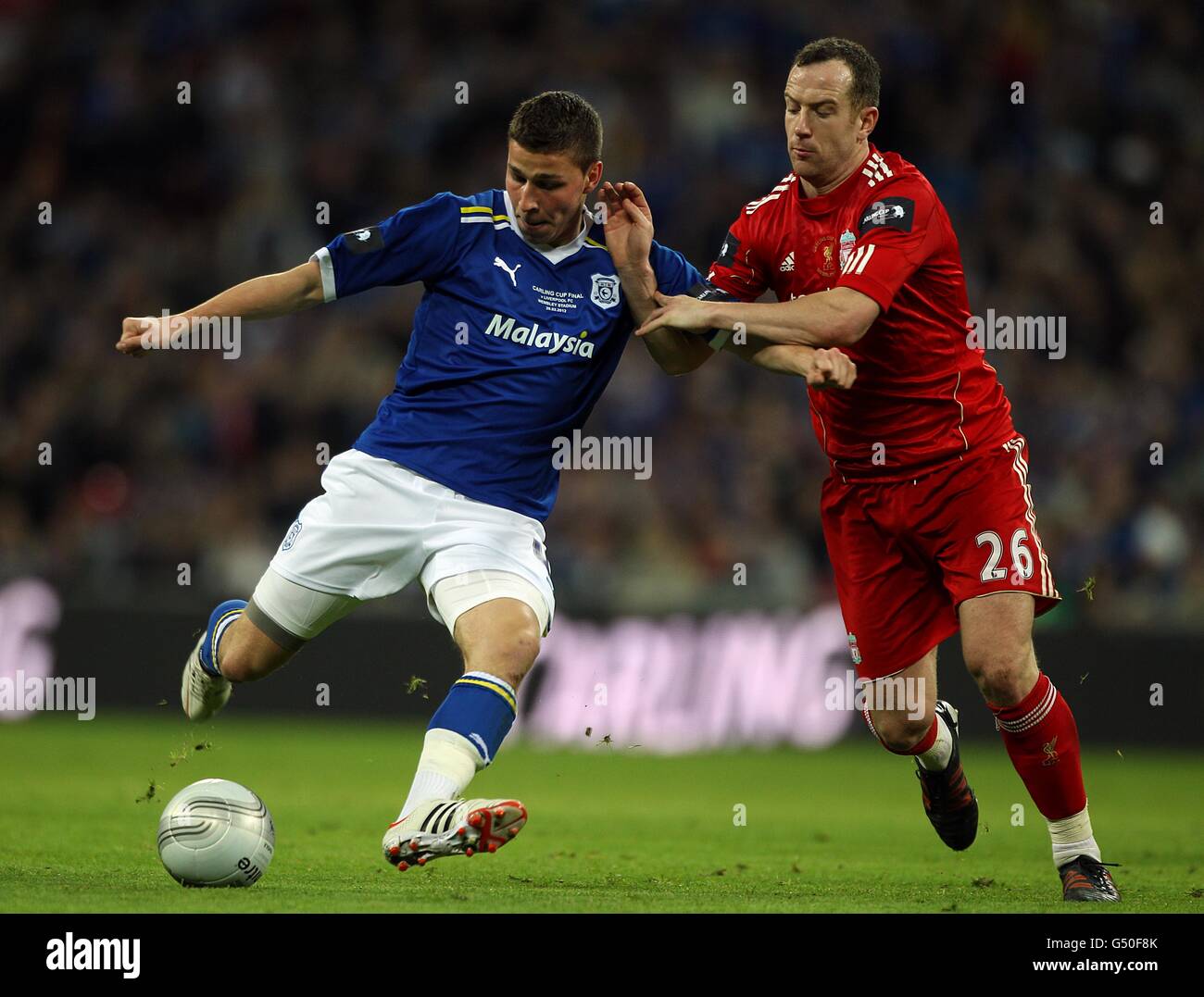 Cardiff City's Filip Kiss (left) and Liverpool's Charlie Adam battle ...