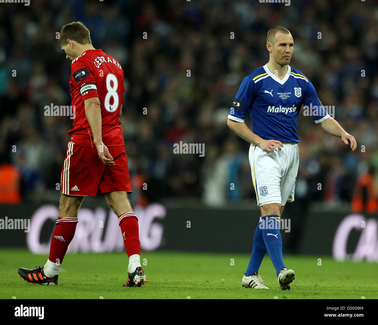 Liverpool's Steven Gerrard (left) walks back to the centre circle after ...