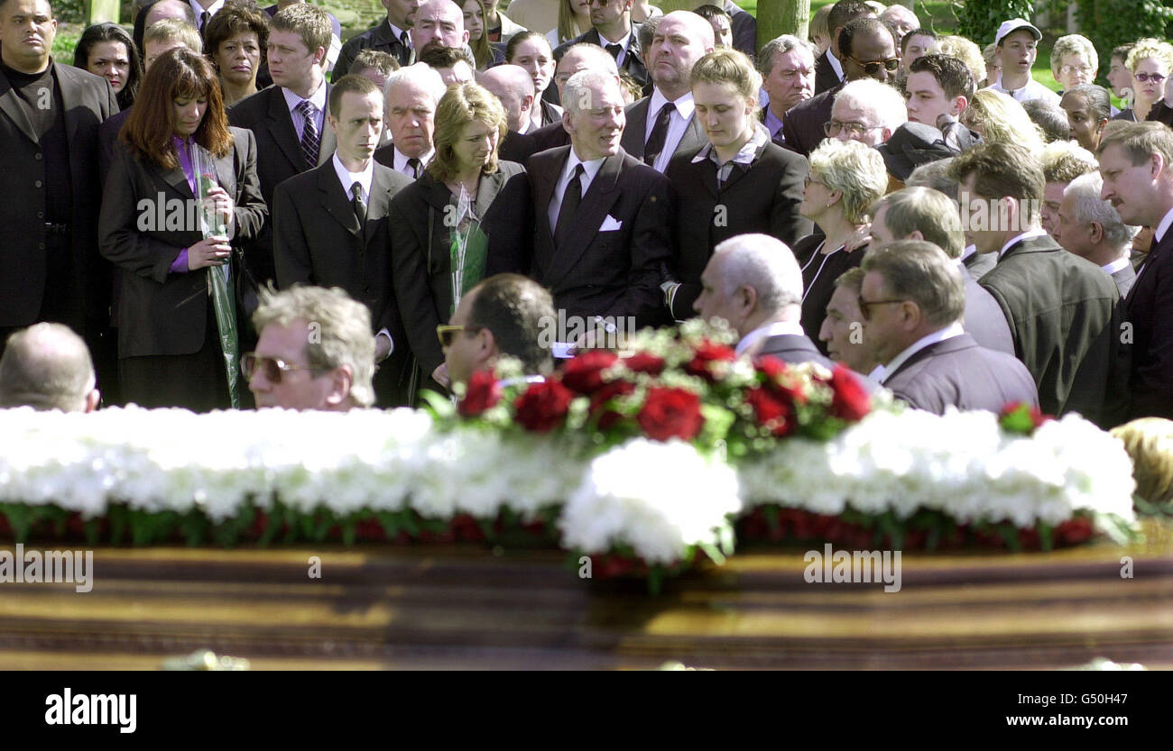 The flower covered coffin of Charlie Kray, passes in front of Reggie ...