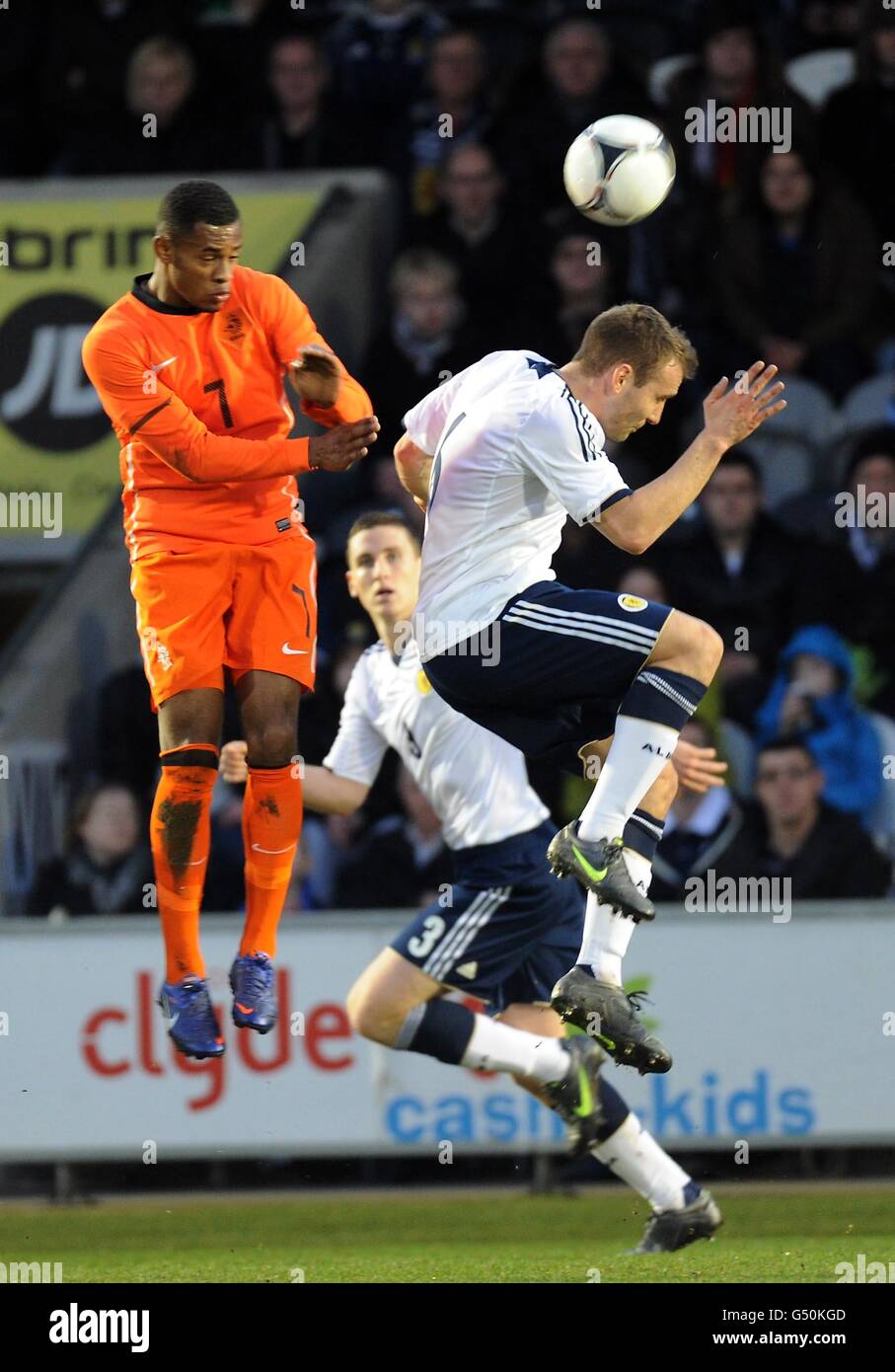Holland's Leandro Bacuna (left) and with Scotland's Liam Kelly battle ...