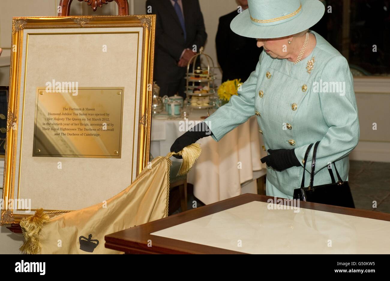 Queen Elizabeth II unveils a plaque, officially opening the "Fortnum ...