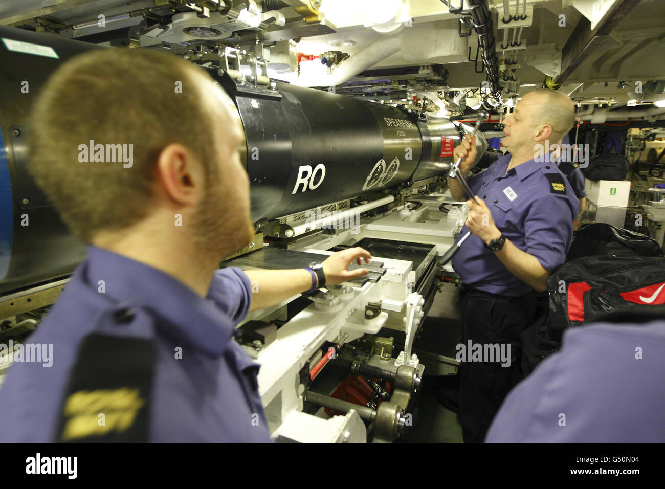 Submariners check a Spearfish torpedo in the 'bomb shop' aboard the ...