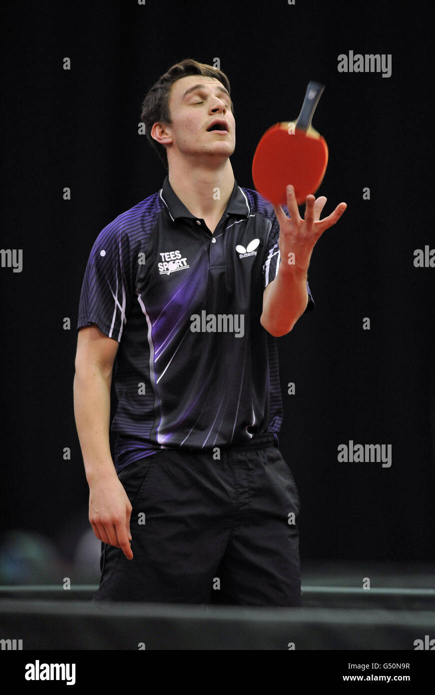 Matt Ware throws his racket up into the air after losing a point during ...