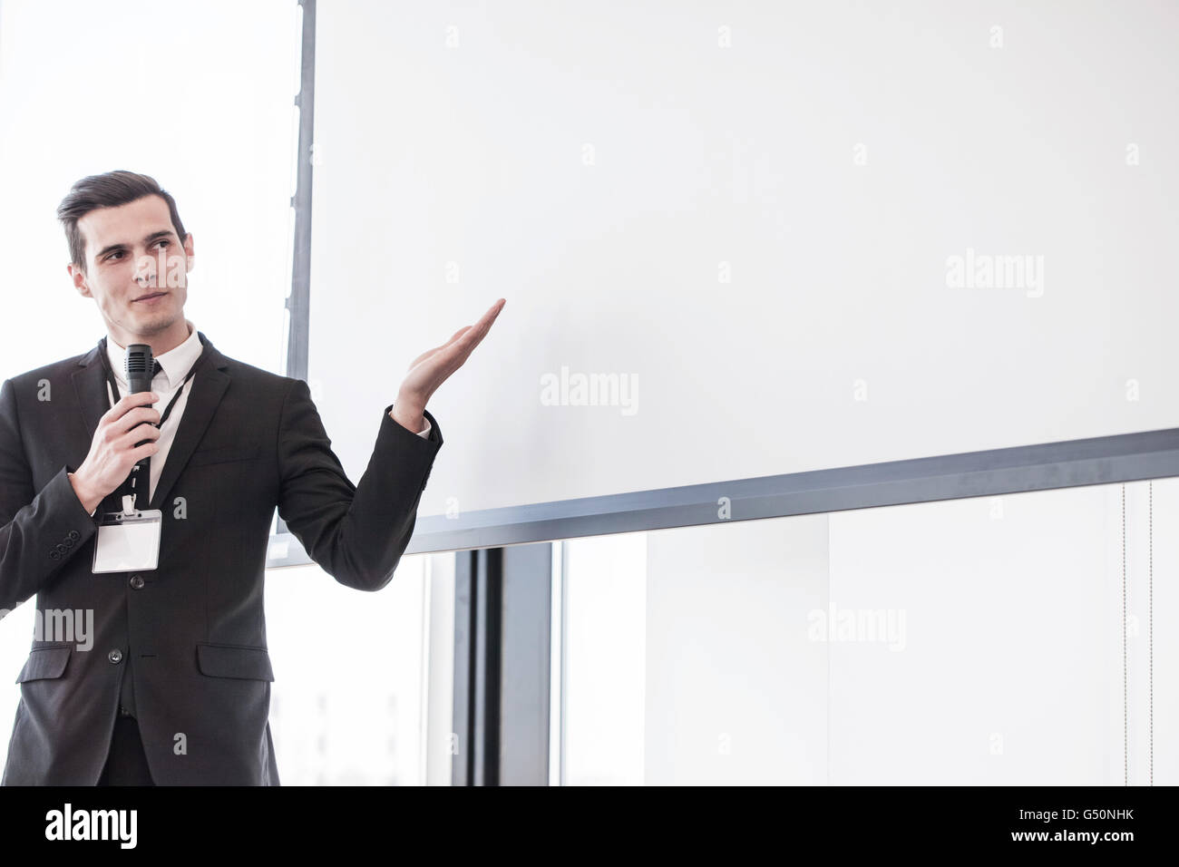Business man speaking at presentation in microphone in office Stock ...