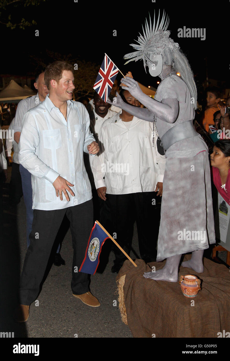 Prince Harry meets a human statue during a walkabout at a "block party ...