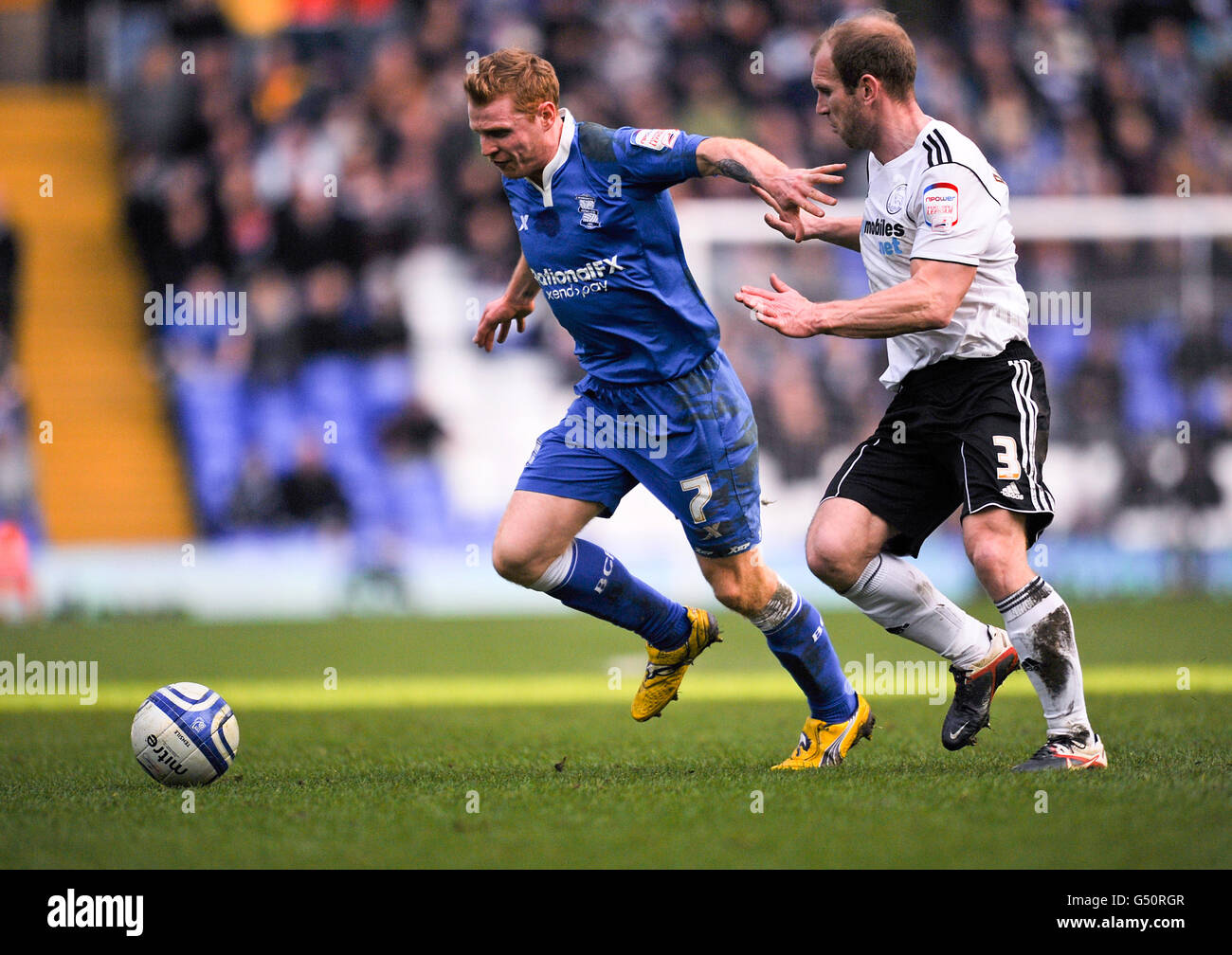 Birmingham City's Chris Burke is challenged by Derby County's Gareth ...