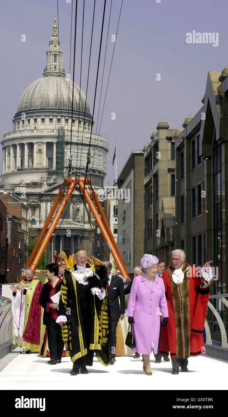 The Queen walks on the Millennium Bridge in London, as she talks to the ...