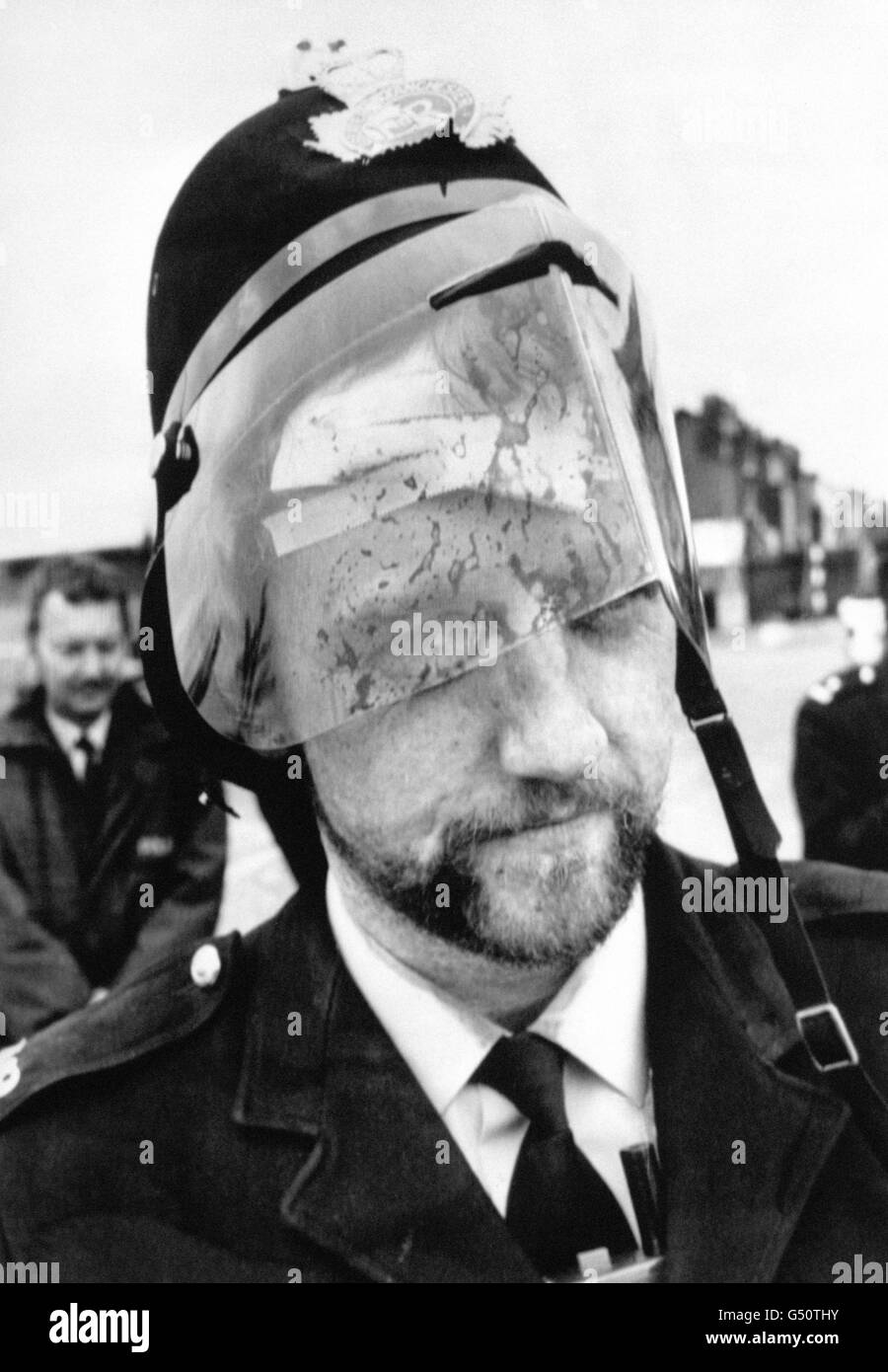 One of the weary blood splattered policemen injured during the riots in ...