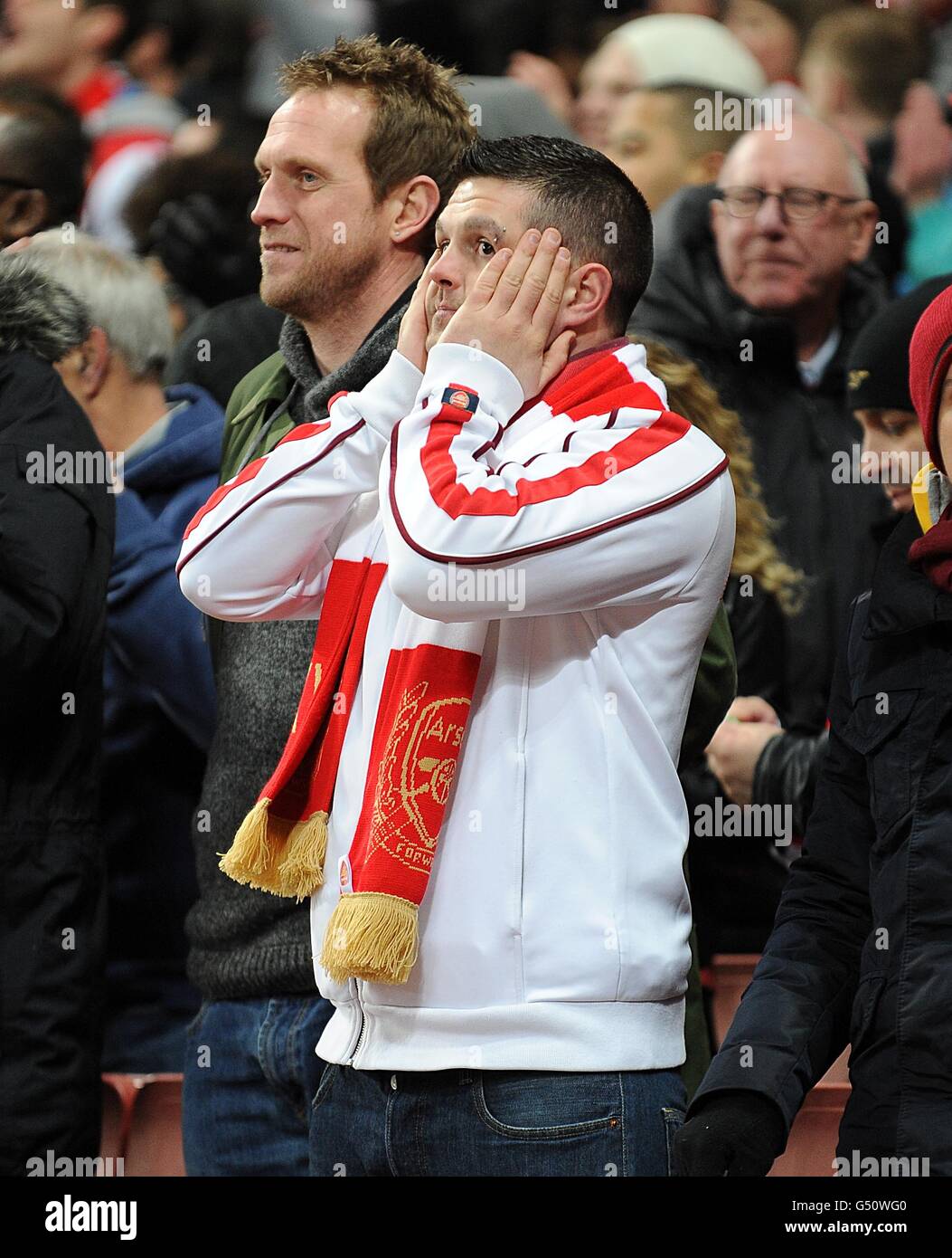 Emirates stadium arsenal fans look nervous in the stands hi-res stock ...