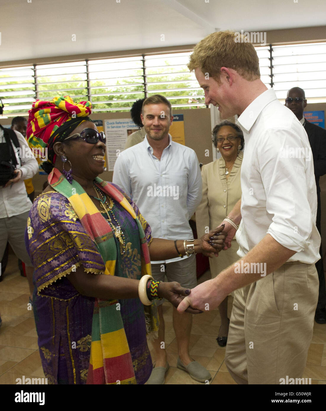 Prince Harry meets Rita Marley, widow of singer Bob Marley, watched by ...