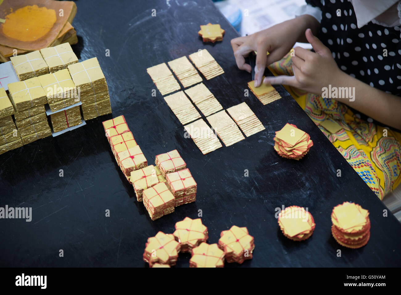 Counting gold leaves at a manufacturer's office, Mandalay, Mandalay ...