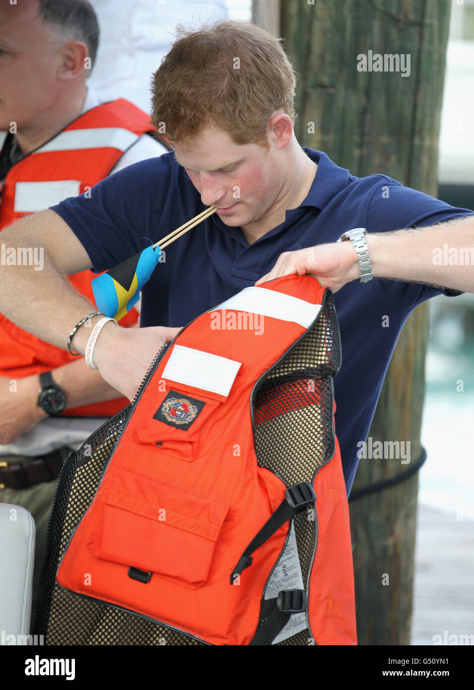 Prince Harry puts on his life jacket as he leaves Harbour Island in ...